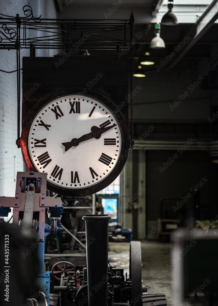 Old fashioned vintage big industry factory clock hanging with roman ...