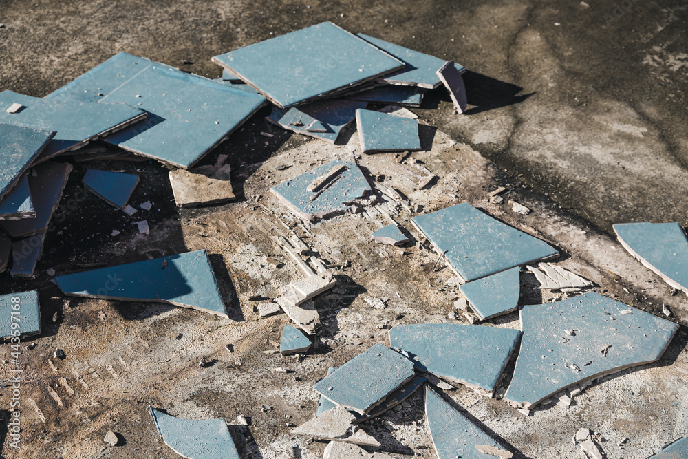 blue outdoor tiles getting ripped up to reveal concrete paving ...