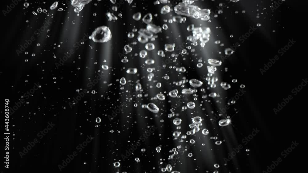 Soda water bubbles splashing underwater and floating water drop in black background. Motion ...