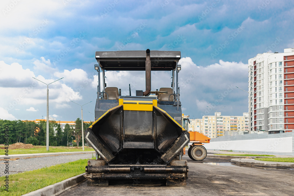 Asphalt paving equipment. Asphalt paver and heavy vibratory roller ...