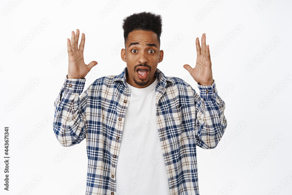 Shocked african american guy making head explosion gesture, holding ...