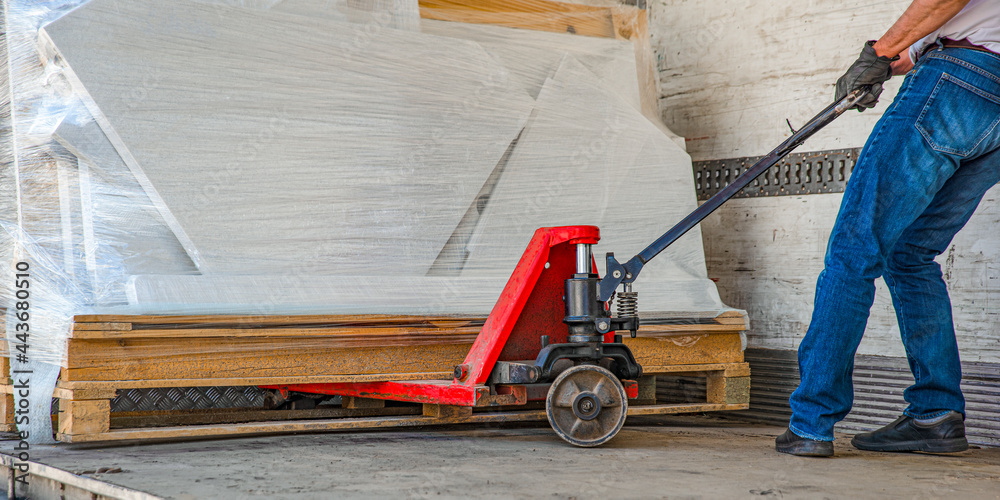 Manual loader. A forklift is towing a hand pallet truck. Folds and ...