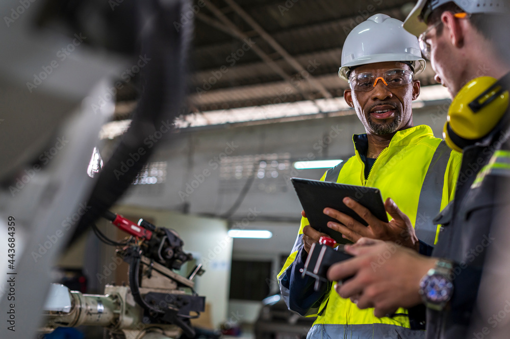 Robotics control engineers setting and maintain spare parts of ...