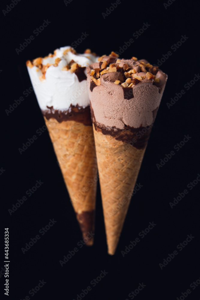 Two ice cream cones, one of cream and the other of chocolate Stock ...