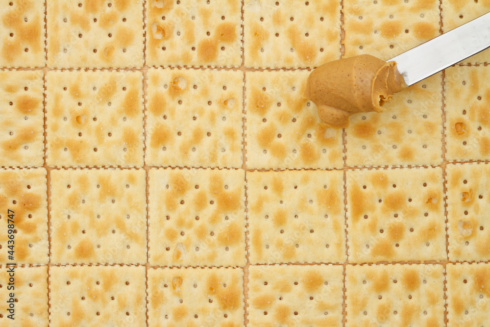 Saltine crackers background with knife full of peanut butter Stock ...