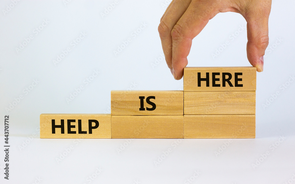 Help is here and support symbol. Wooden blocks with words 'Help is here ...