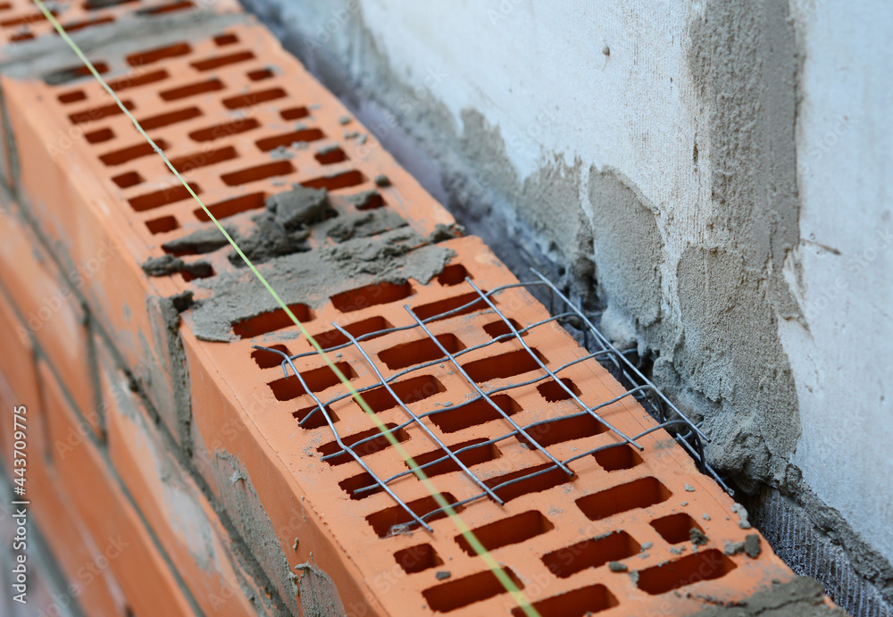 Wall ties in brick masonry. A close-up of a masonry wall tie, mesh wall ...