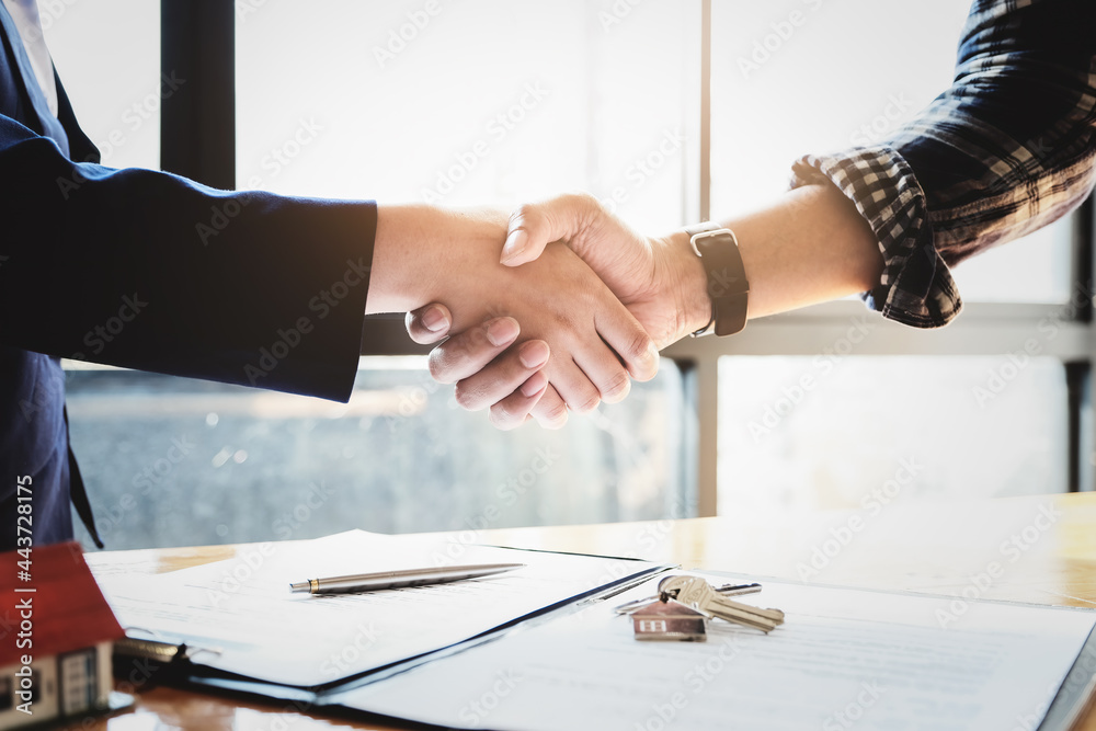 Focus on the congratulatory handshake. The real estate agent agrees to ...