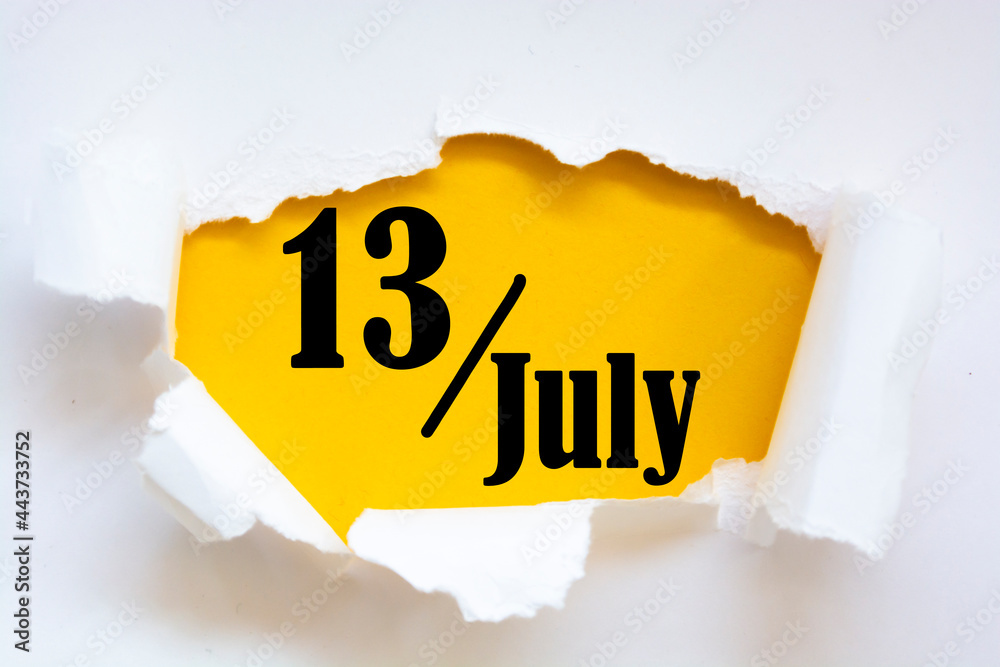 July 13. 13th day of the month, calendar date. Hole in paper with edges ...