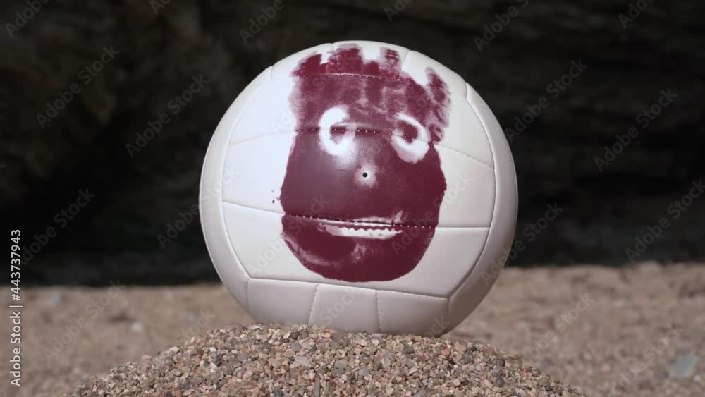 Vidéo Stock Volleyball ball with face painted on it stands on pile of ...