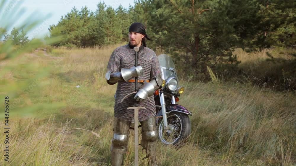A medieval knight in a full set of armor and a bandana on his head ...