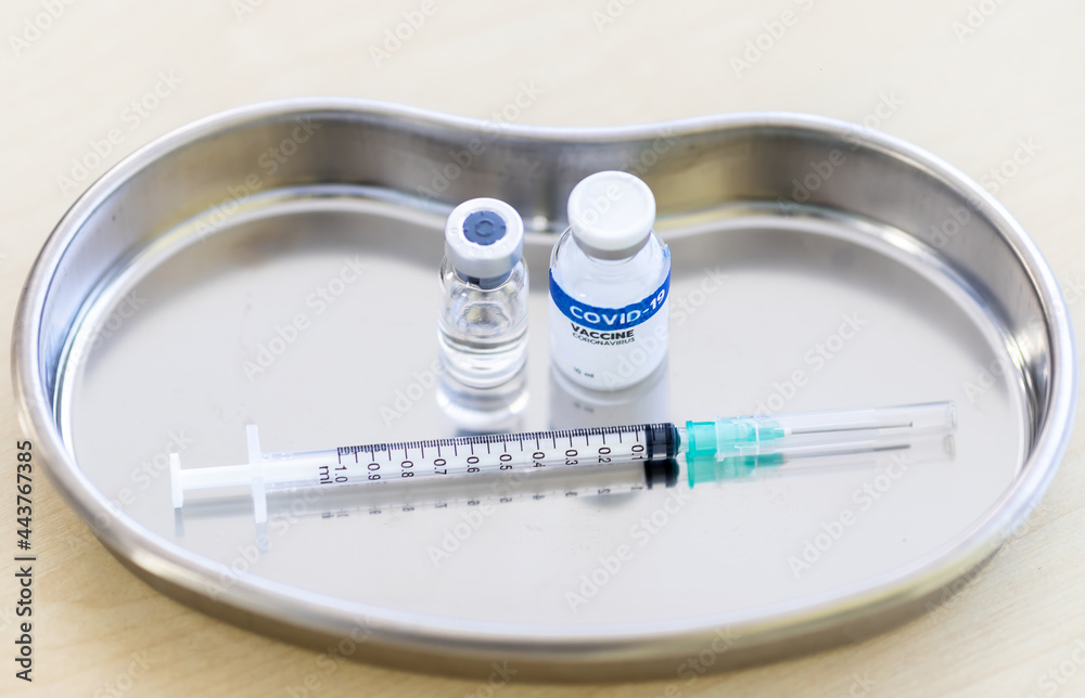 Vaccination concept and medicine: syringe with coronavirus vaccine and ...