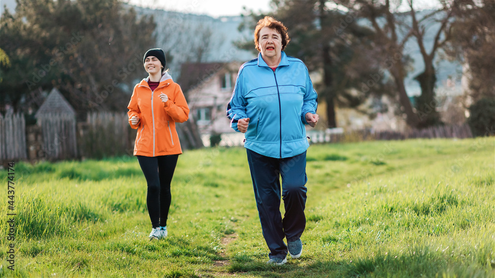 Happy caucasian grandmother and granddaughter running together. Old and ...