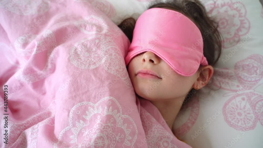 Sleeping little girl in sleep in bed late in morning. Pretty child ...