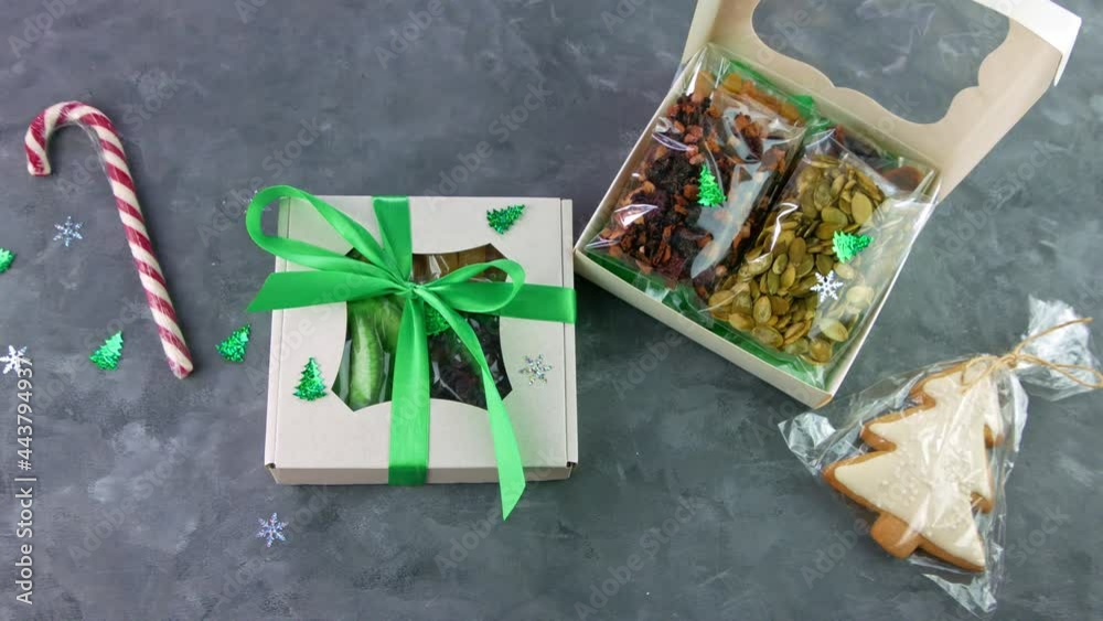 Vídeo do Stock: Girl wraps gift box with dried fruits nuts individually ...