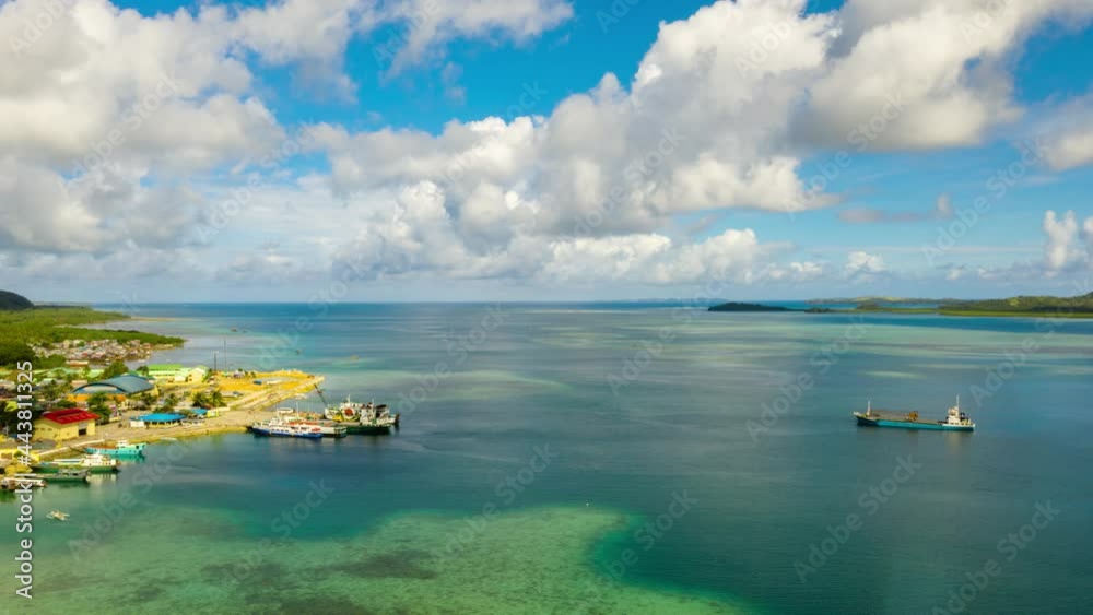 Hyperlapse: Ferry terminal with ferry and ships in the town of Dapa ...