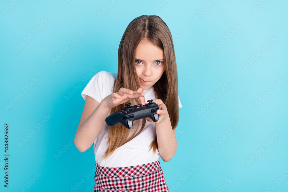 Photo of cute brown hair small girl playstation wear white t-shirt ...