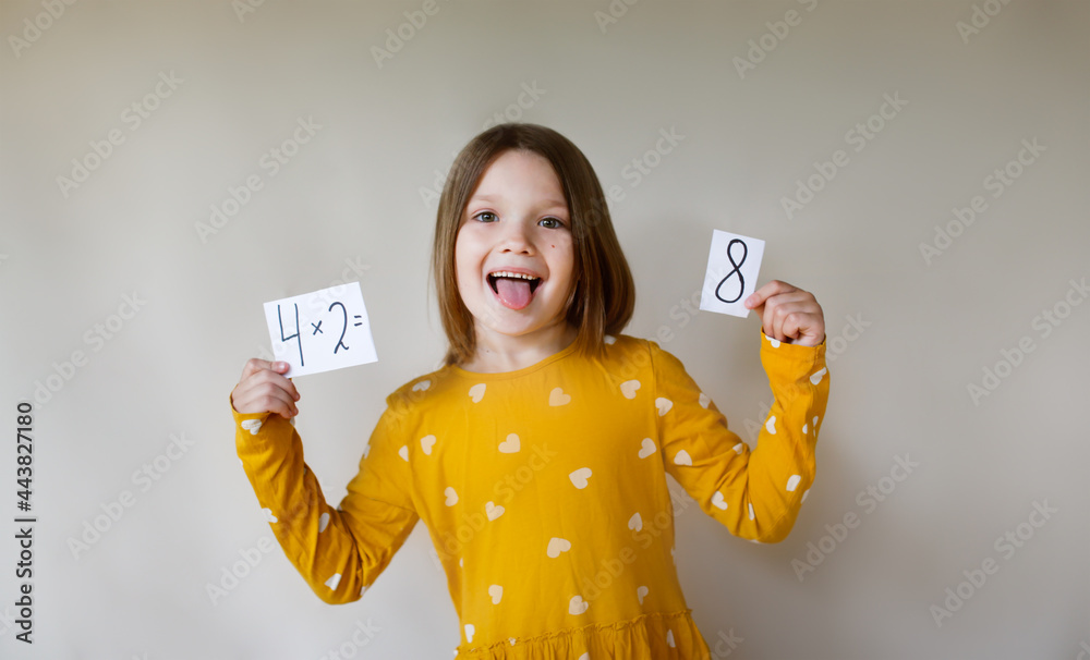funny crazy cute kid girl in mustard dress learns the multiplication ...
