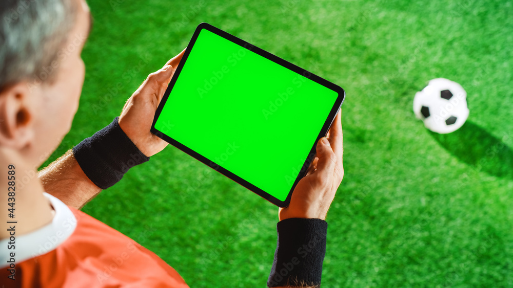 Professional Soccer Player Holding Digital Tablet Computer with Green ...