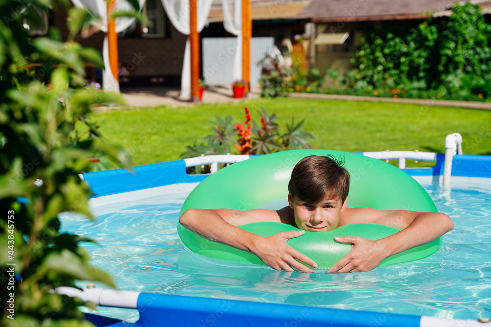 Summer pool with green circle and laughing guy sunbathing. Children in ...