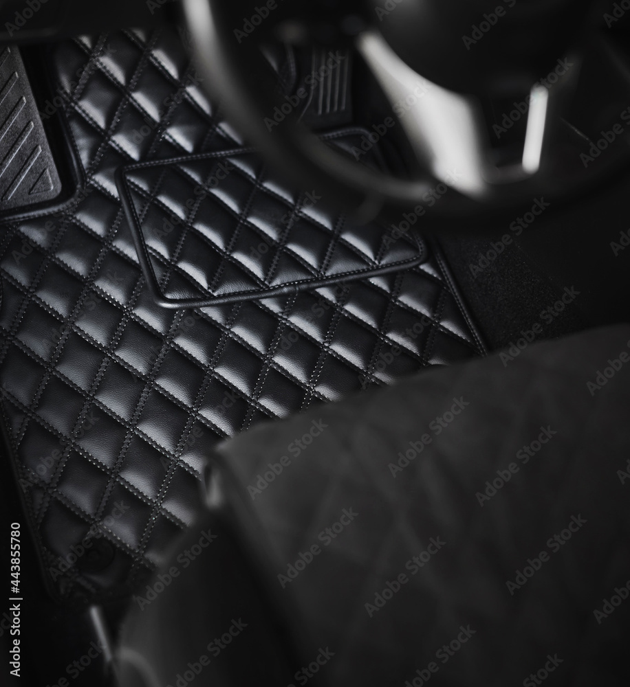 driver seat in the modern luxury car. luxury leather black floor mat ...