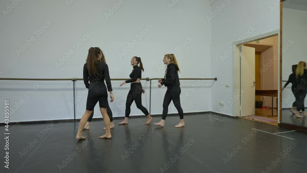 Live camera follows group of beautiful slim young women entering dance ...
