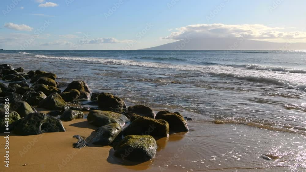 Rocky Beach - An evening view of strong waves rushing in and out of ...