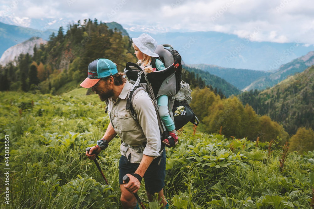 Family hiking father with child in backpack traveling together in ...