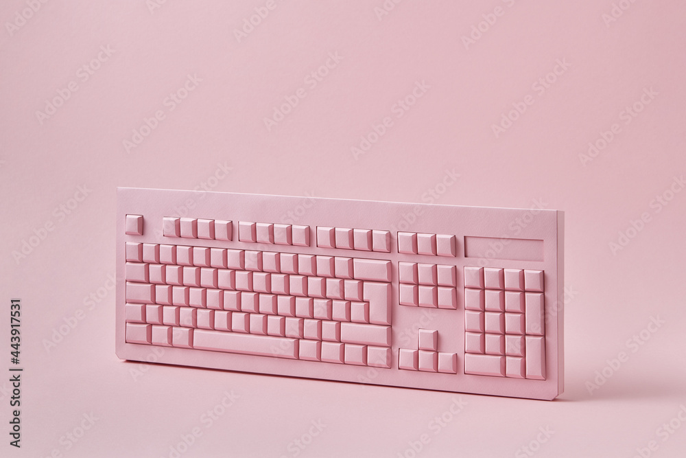 Vertically standing papercraft pink keyboard. Stock Photo | Adobe Stock