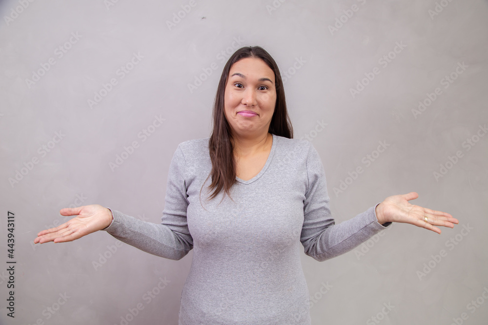 Confused young woman on gray background with space for text. woman ...