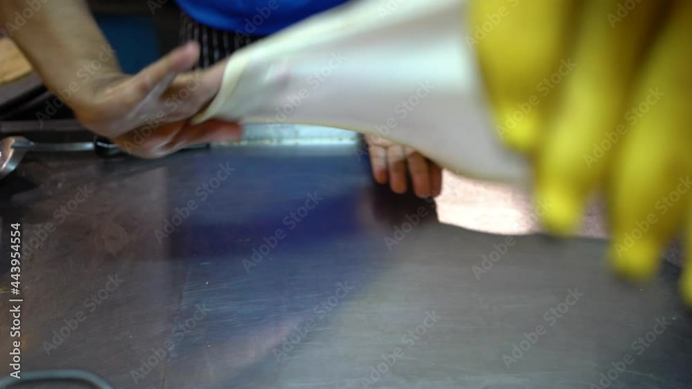 Hands of street vendor cooking roti is frying and preparing. Indian ...