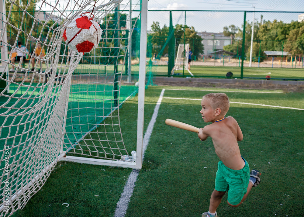 Preschool birthday boy hitting pinata from cardboard and color paper ...