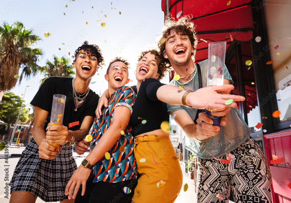 Joyful group of friends celebrating with confetti Stock Photo | Adobe Stock