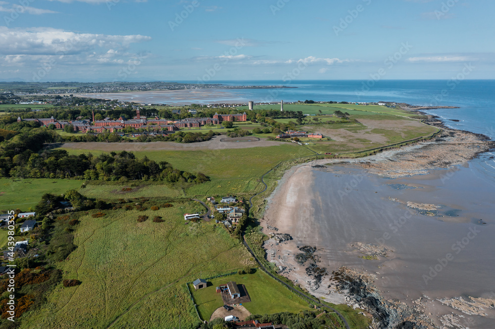 Old brick Quay buildings, the Portrane Round Tower, and Irish landscape ...