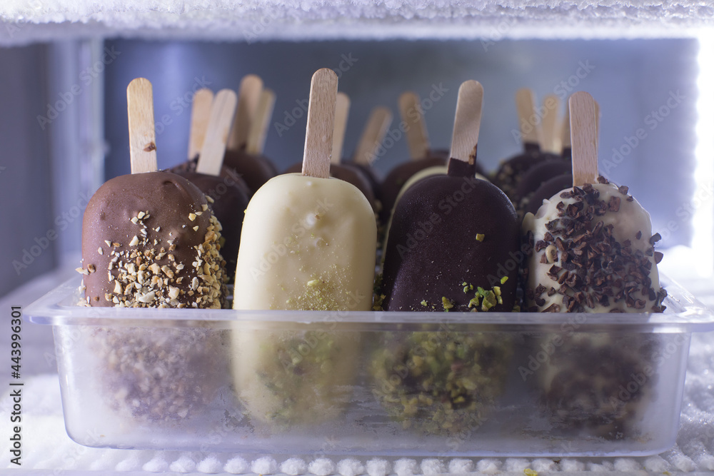 cream and chocolate cakesicles with toppings in a refrigerator Stock ...