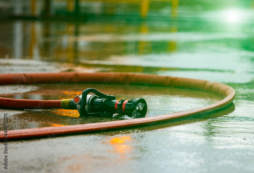 Water jet splashing from a fire fighting firehose nozzle Stock Photo ...