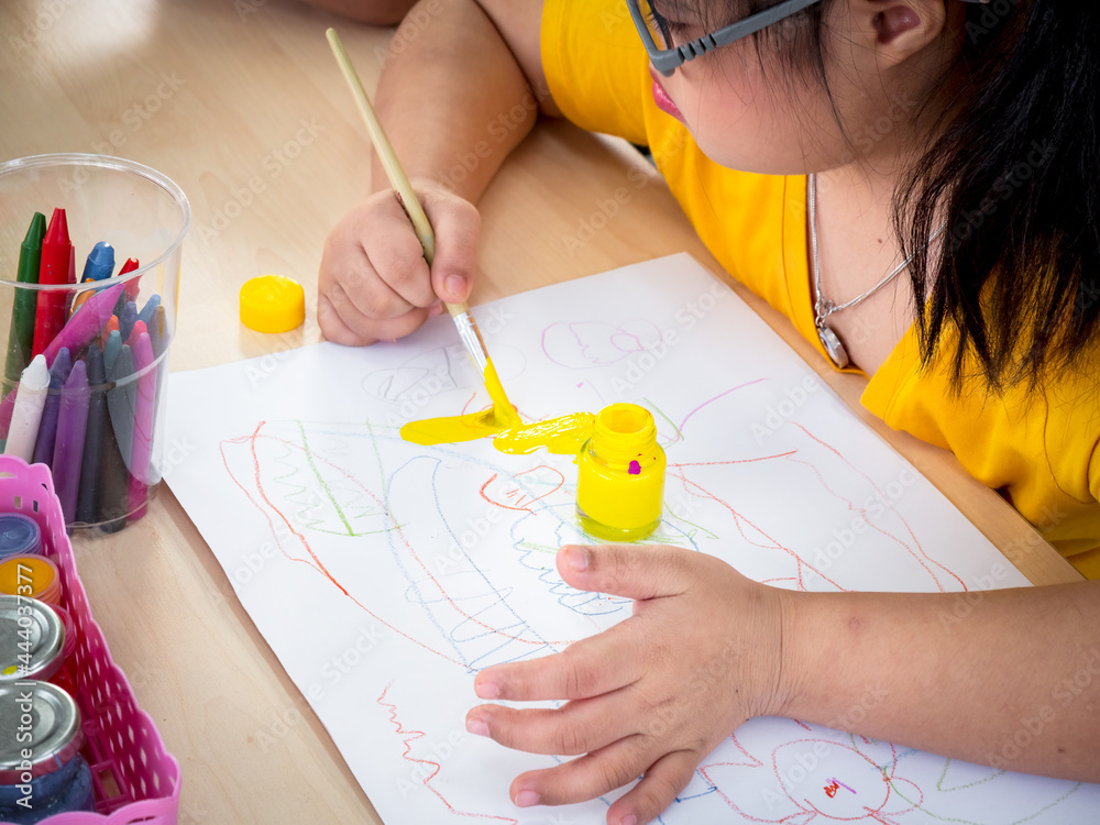The cute little girl down syndrome learning about drawing and painting ...