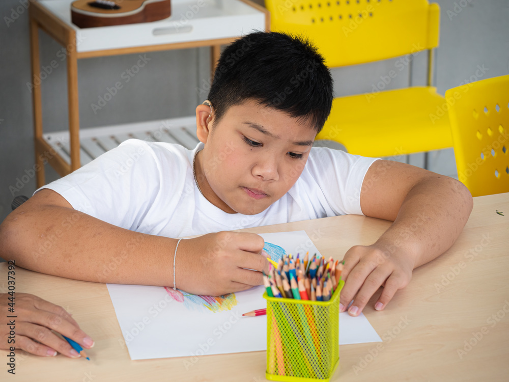 The disabled child in the wheelchair is learning about drawing and ...