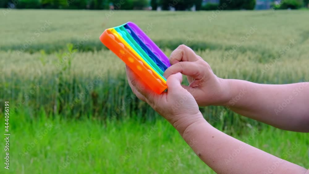 female hands holding rainbow Toy antistress Pop it, poppit -new fidget ...