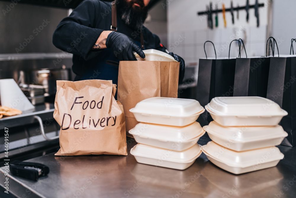 The chef prepares food in the restaurant and packs it. Food in ...