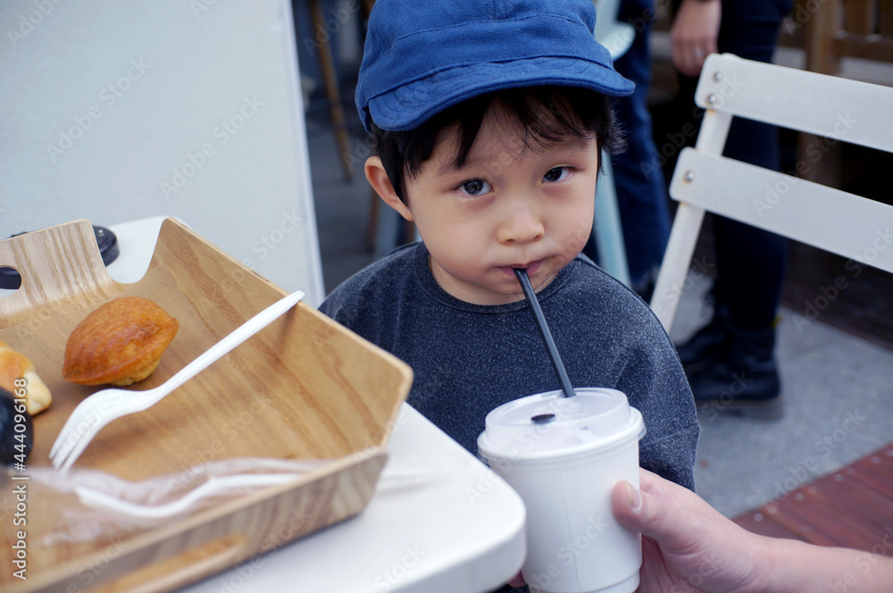 Cute Asian Chinese little boy drinking beverage Stock Photo | Adobe Stock
