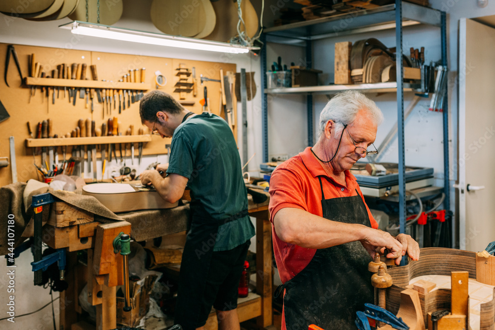 Luthiers working in traditional guitar making business Stock Photo ...