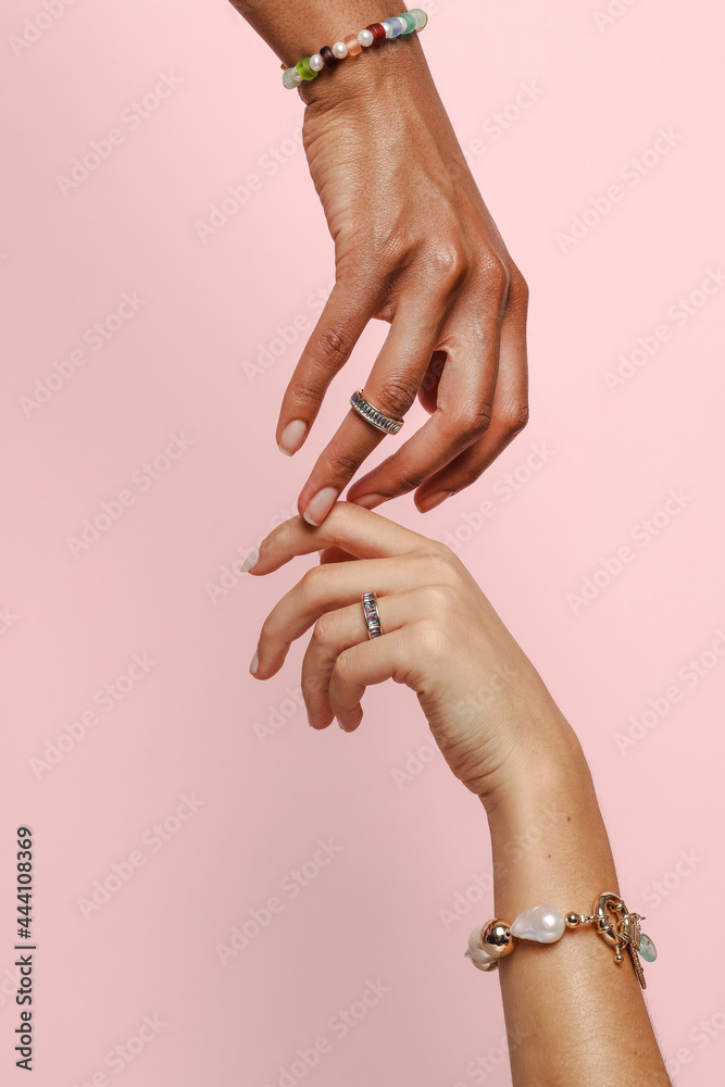 Two female hands with jewelry on holding each other Stock Photo | Adobe ...