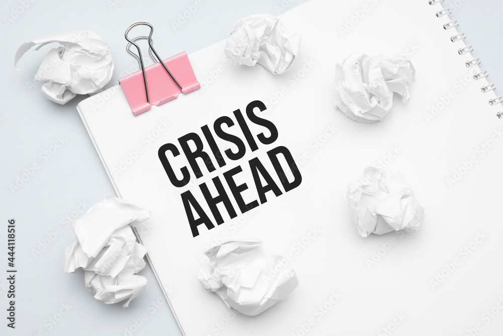 CRISIS AHEAD. Blank sheet of paper, red paper clip, word Ideas and ...