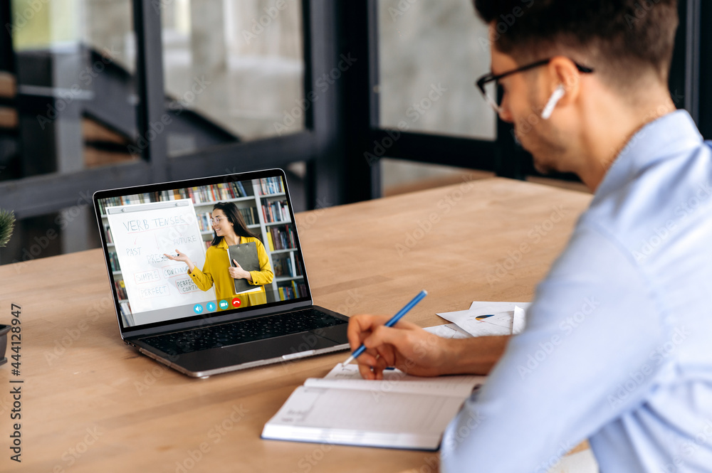 E-learning concept. Clever caucasian male student gains knowledge ...