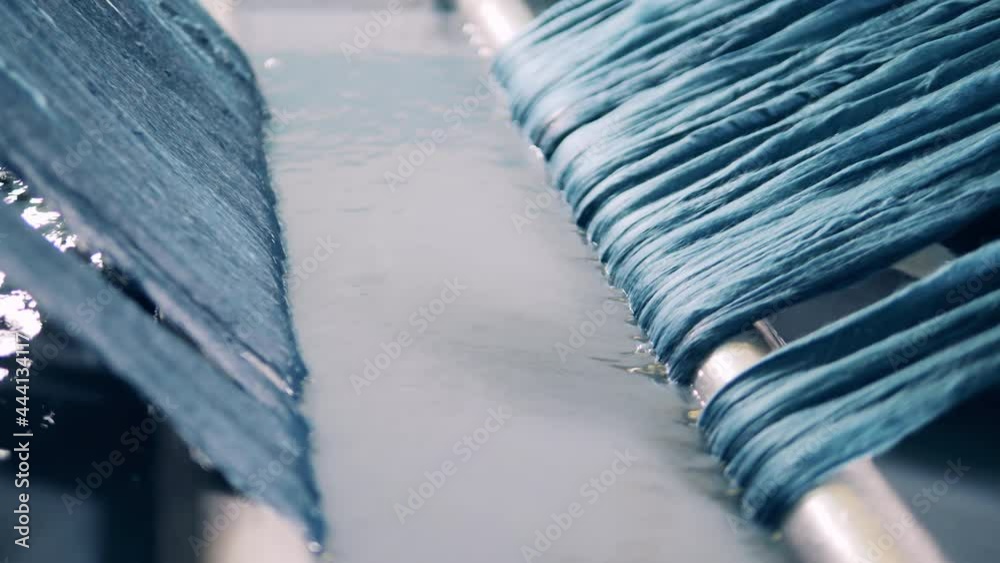 Textile production, clothes manufacturing concept. Strips of yarn are ...