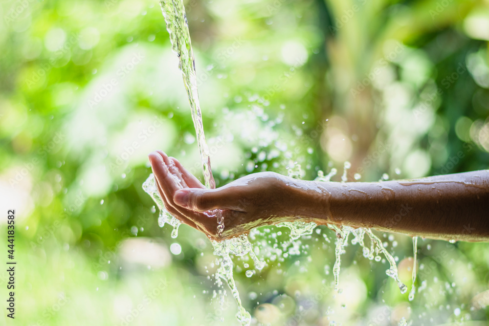 water pouring flow on woman hand on nature background Stock Photo ...