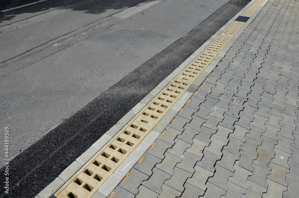 across the path there is a channel with a metal grid for drainage ...