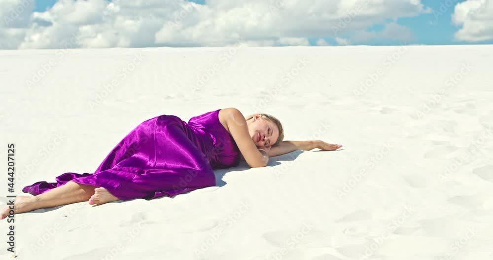 Cinematic slow motion of a woman walking on a sand dune. Barefoot woman ...