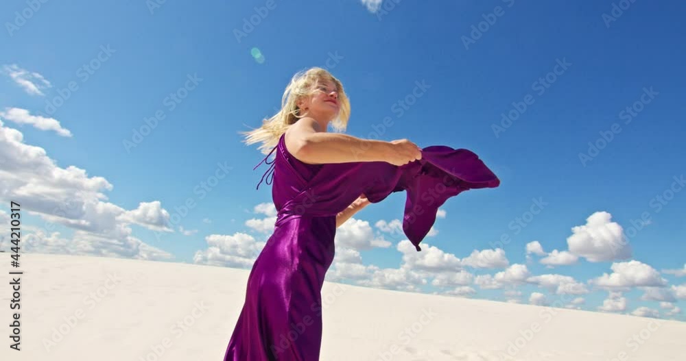 Cinematic slow motion of a woman walking on a sand dune. Barefoot woman ...